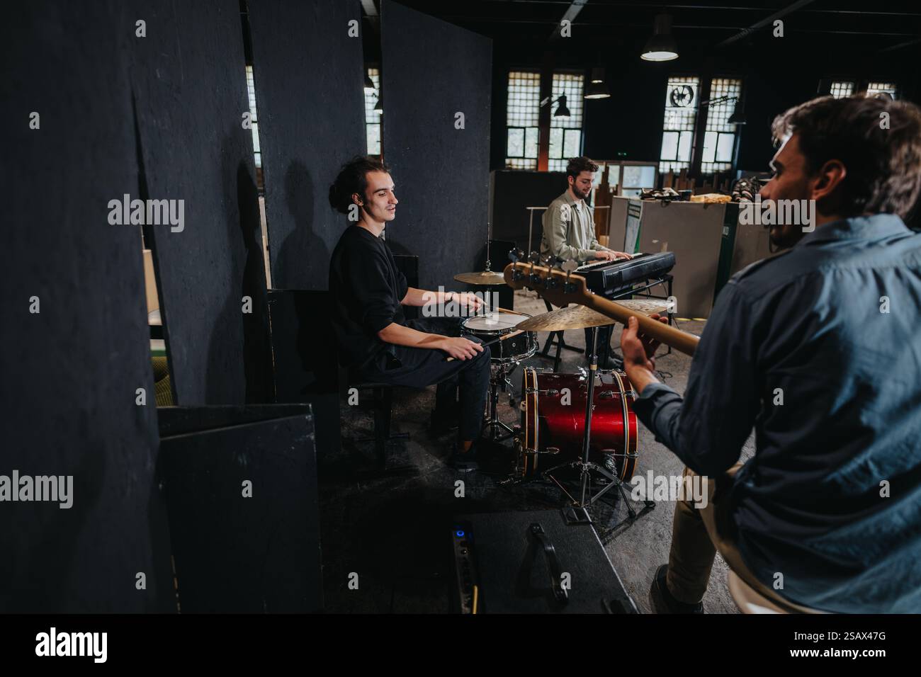 Musicians rehearsing together with instruments in a music studio ...