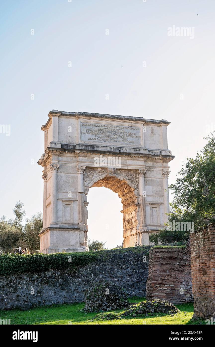 Ancient Roman triumphal arch surrounded by greenery in sunlight Stock ...