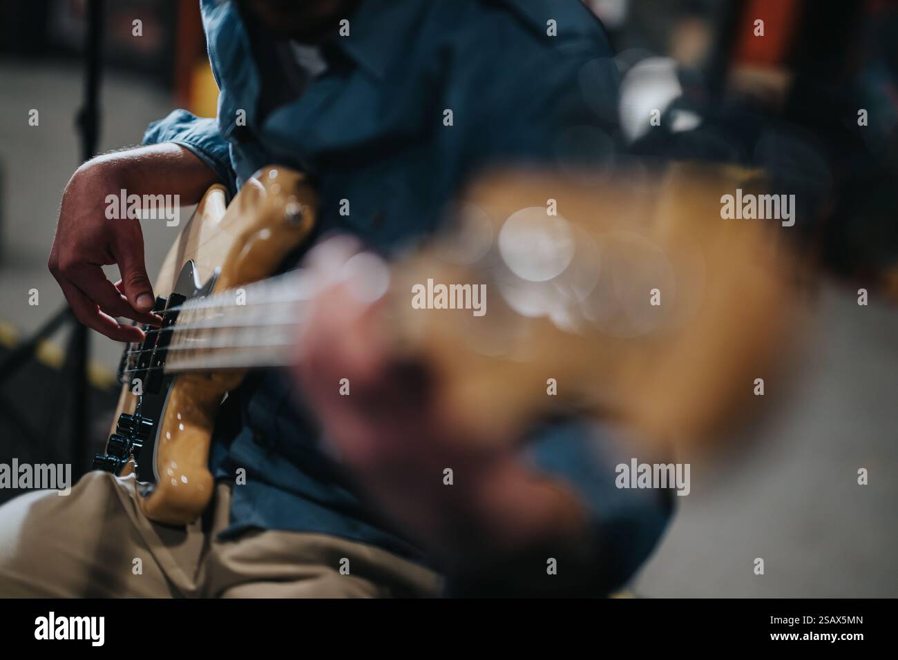 Dynamic image of a guitarist strumming the strings of an electric ...