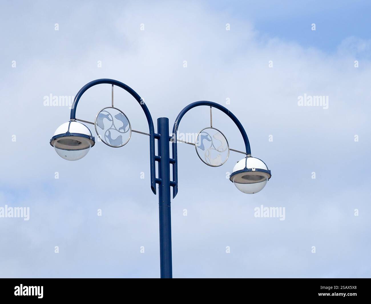 Decorative street lighting showing blue painted curved lamp post with ...