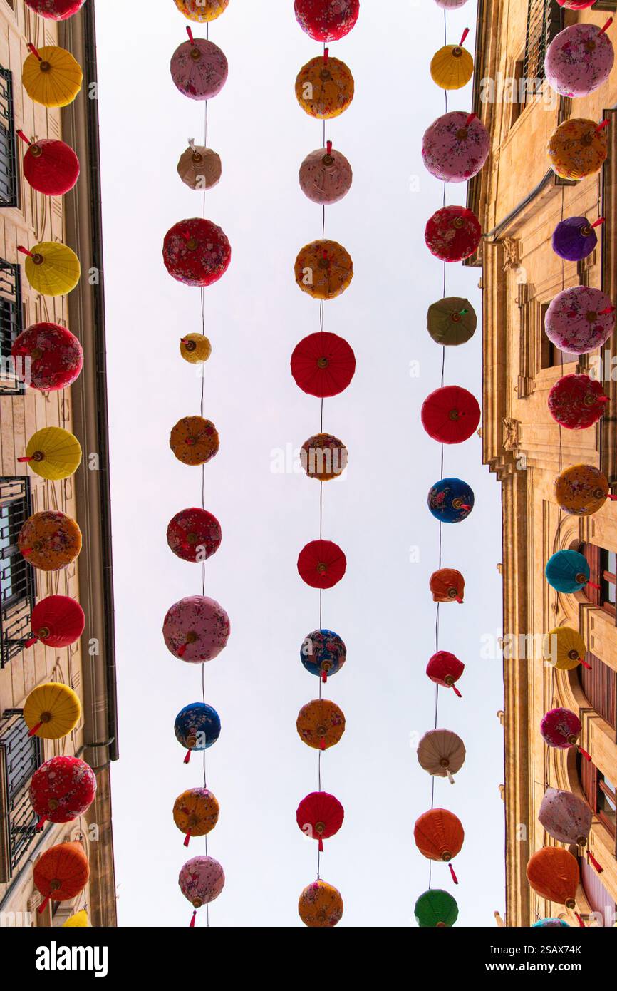A stunning display of colorful Chinese paper lanterns suspended above a ...