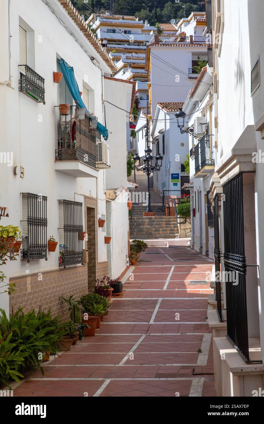 Benalmadena, Spain - April 24th 2024: View up a traditional street in ...