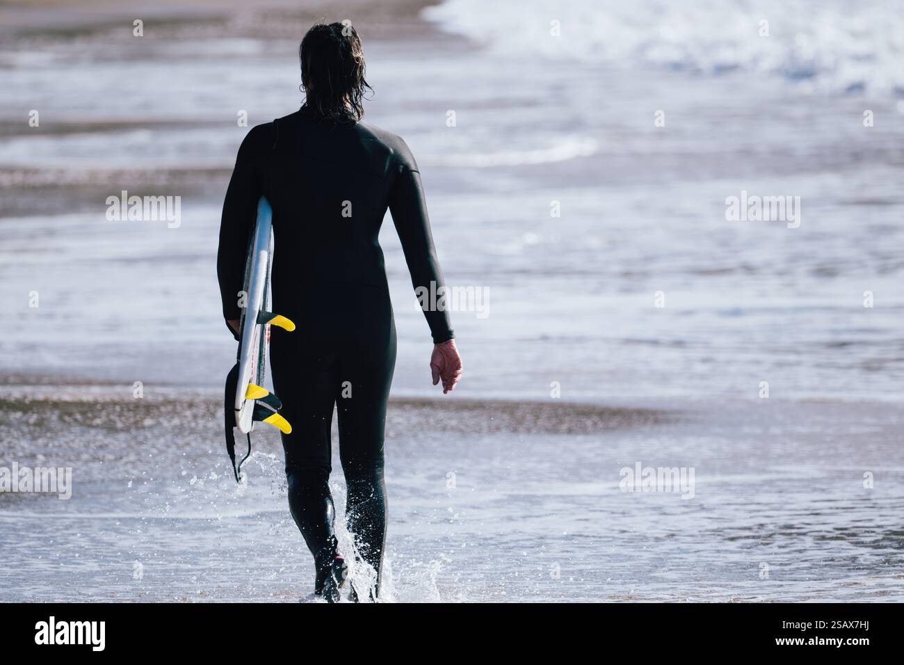 Surfboard under his arm hi-res stock photography and images - Alamy