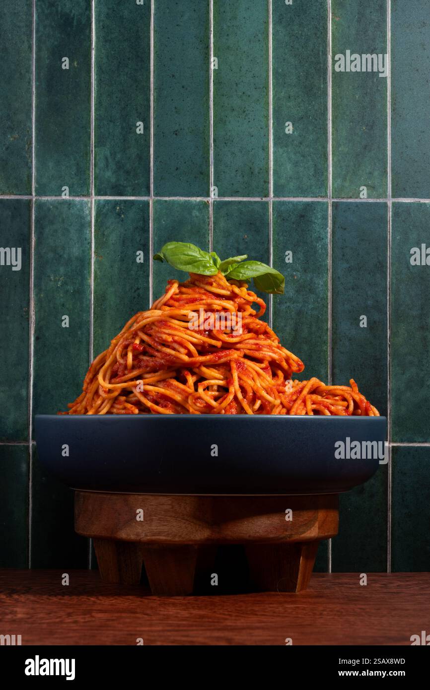 Spaghetti Stack – A tall heap of pasta in rich tomato sauce Stock Photo ...