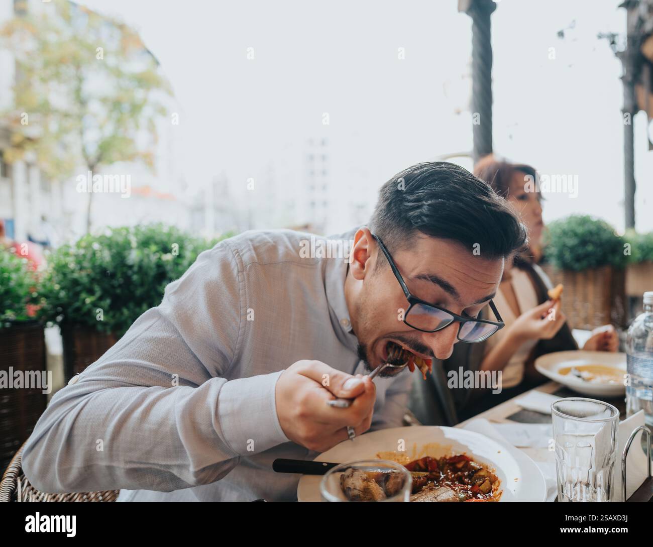 Business people enjoying lunch at an outdoor restaurant Stock Photo - Alamy