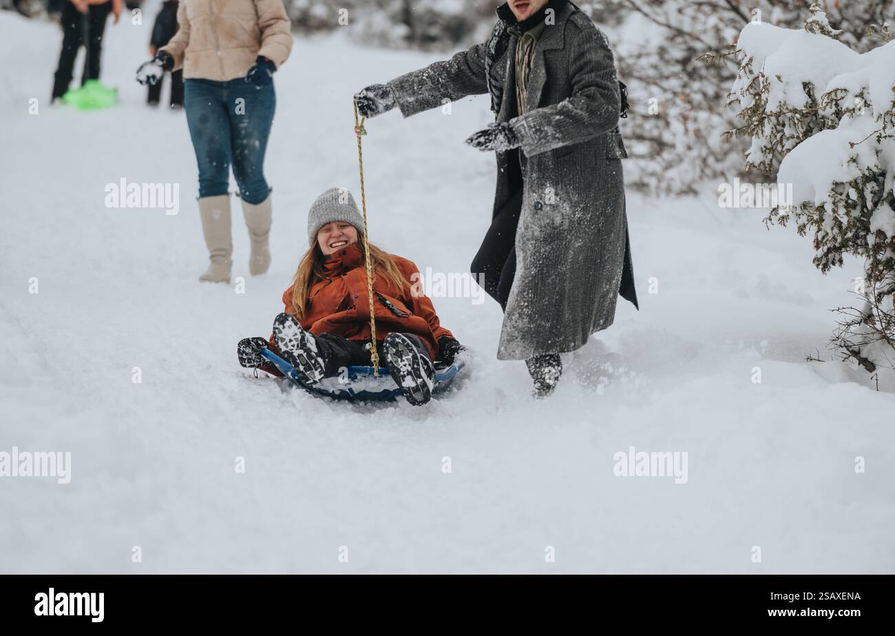 Winter Fun with Friends Enjoying a Day Sledding in the Snow Stock Photo ...