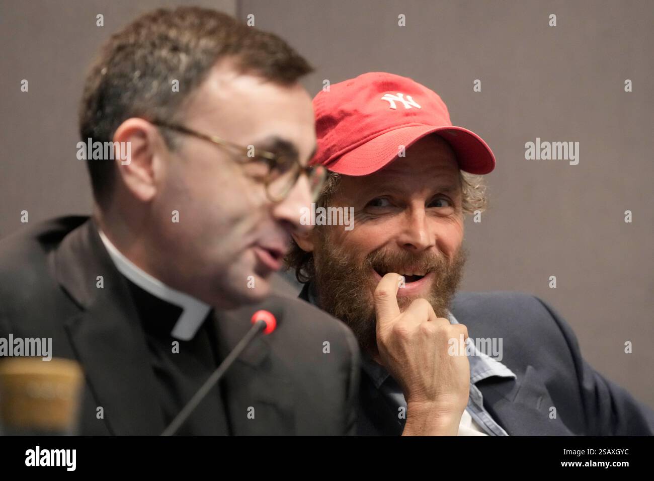 Don Giacomo Cardinali, left, and Italian artist Lorenzo Jovanotti Cherubini attend a press ...