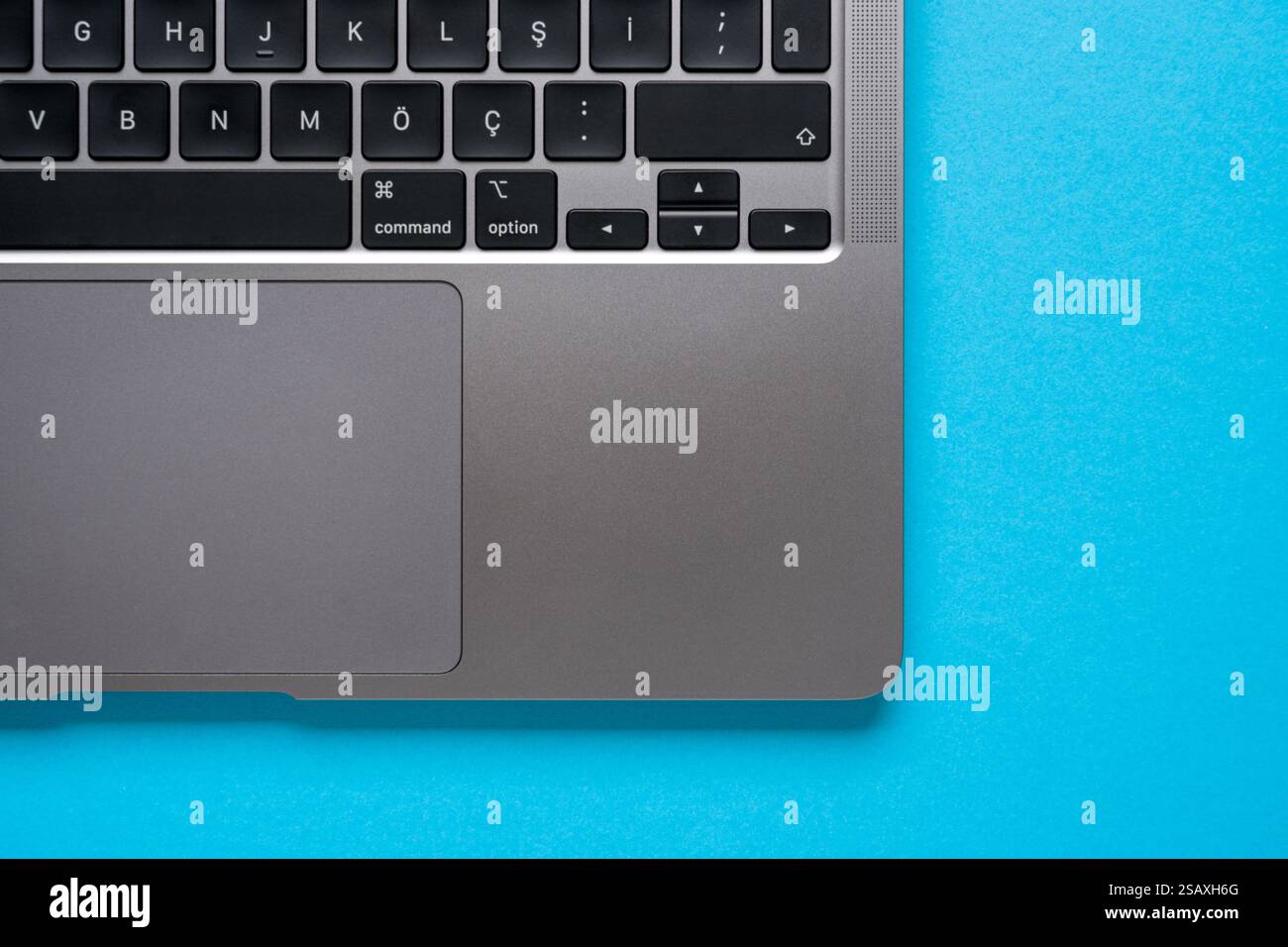 Top view of corner and keyboard of laptop on blue table Stock Photo - Alamy