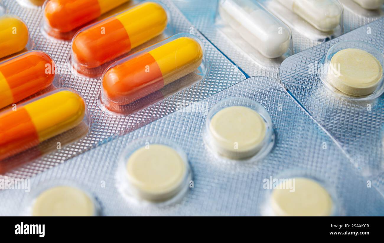 Different capsules and tablets are neatly arranged together, showcasing ...