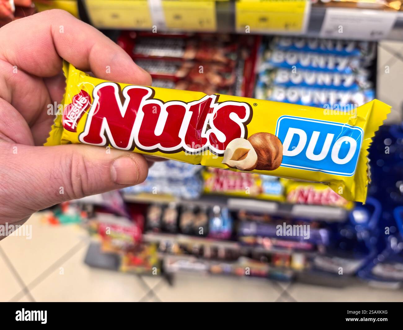 Bobruisk, Belarus - January 24, 2025: A hand holds a bright yellow ...