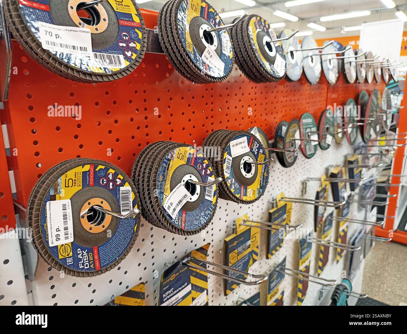 Abrasive grinding discs displayed on store shelf with pegboard Stock ...
