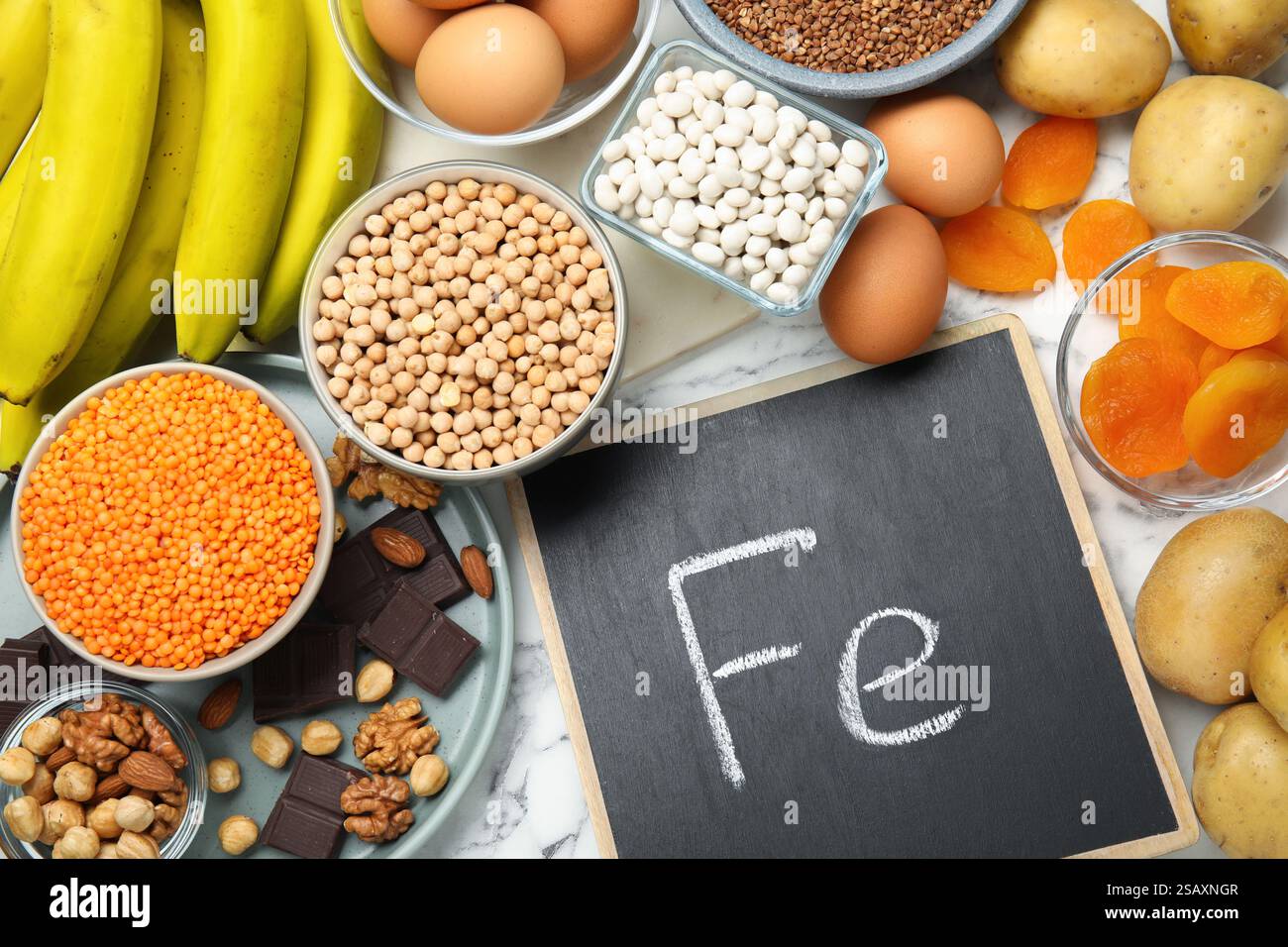 Different products rich in iron and small chalkboard with Ferrum symbol ...