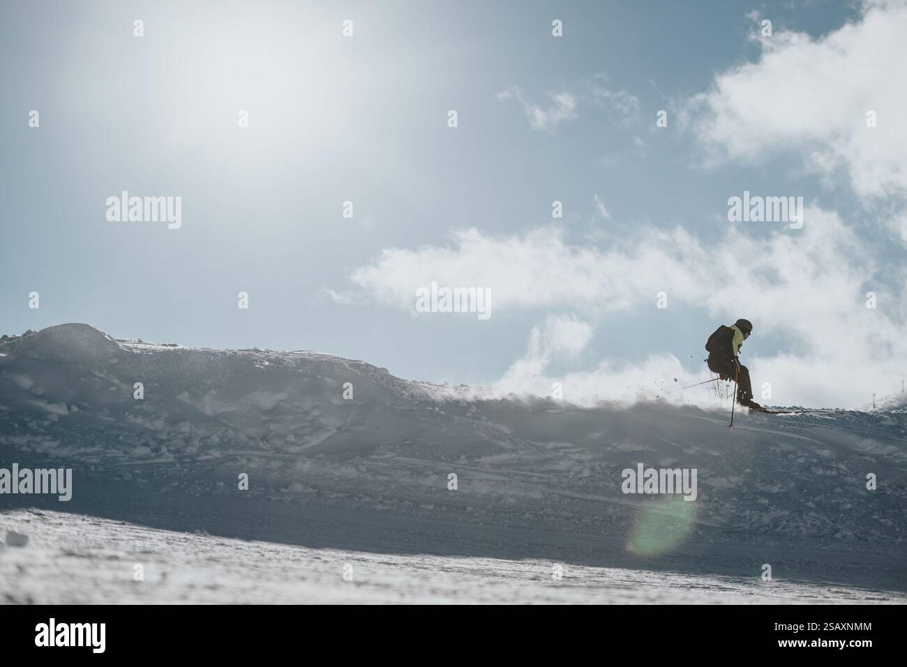 Skier Descending a Snowy Slope in Bright Sunny Weather Stock Photo - Alamy