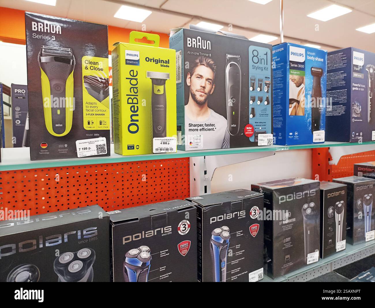 Electric razors display shelf in retail store with various brands and ...