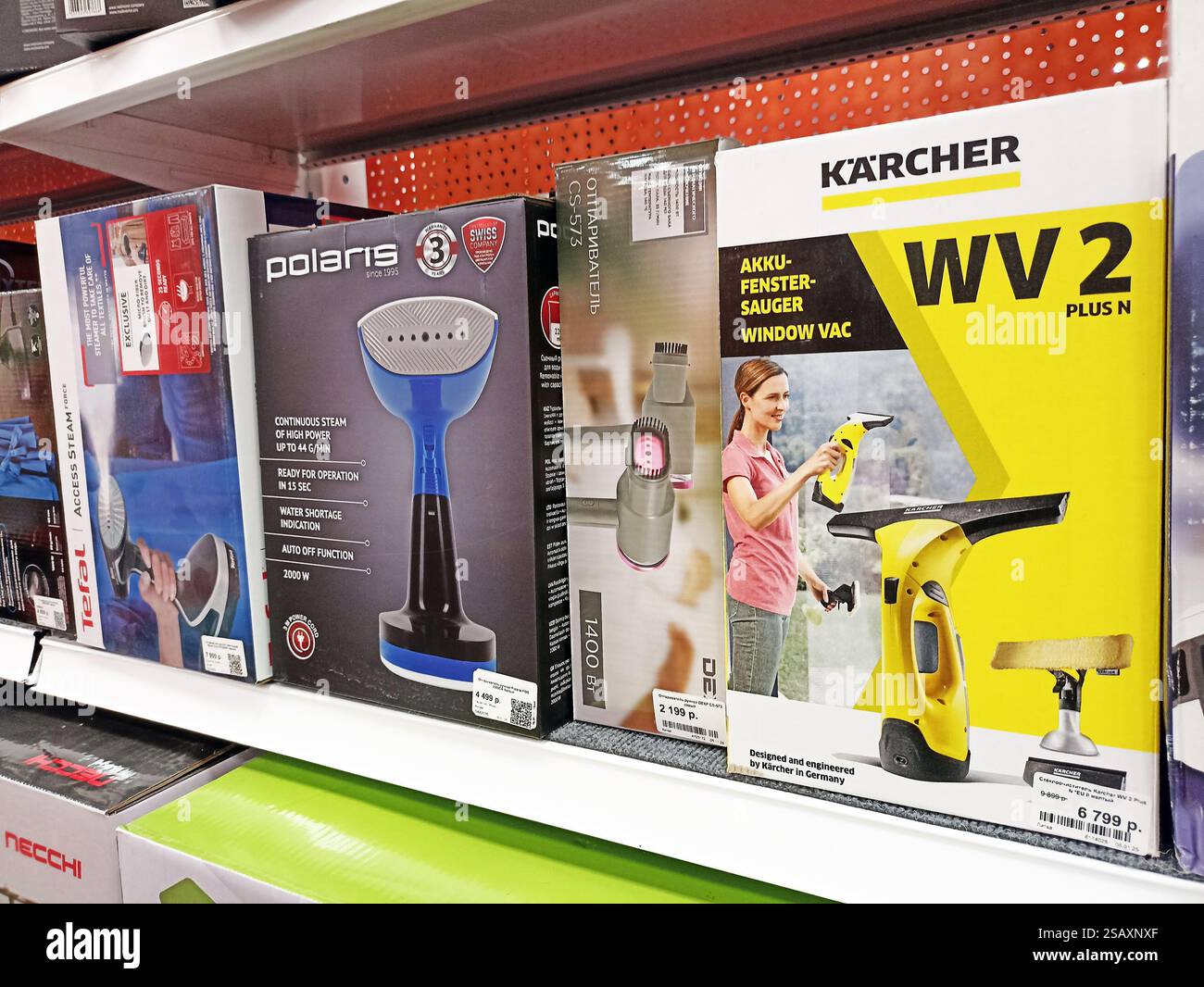 Home appliance store display: steam iron, window vac, cordless cleaner ...