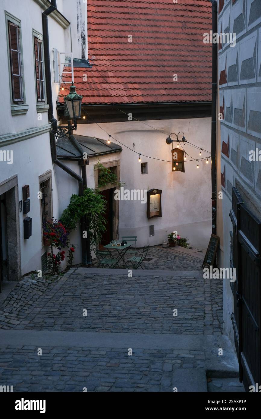 Cozy Alley with String Lights and Outdoor Seating Stock Photo - Alamy