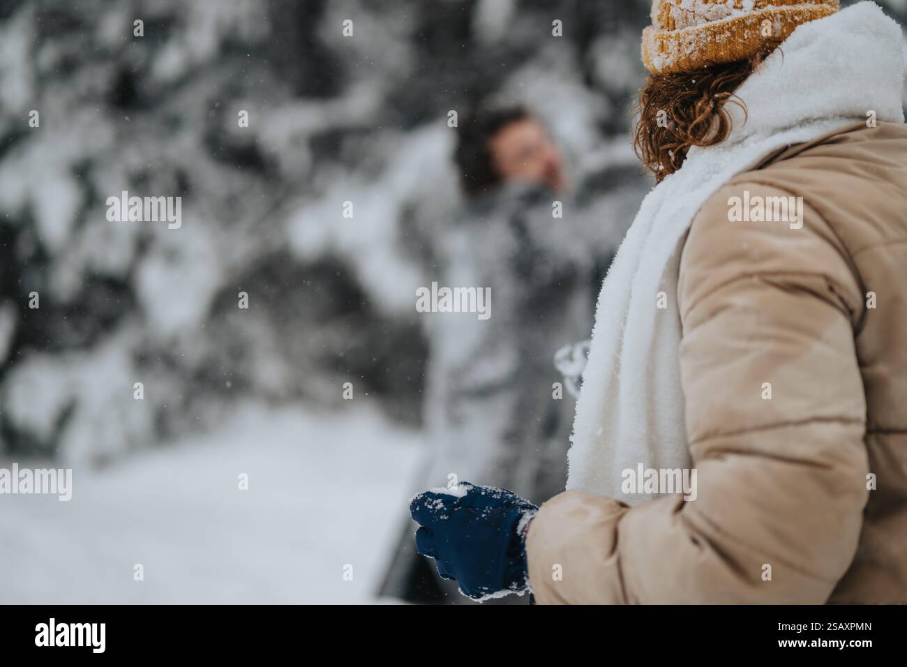 Two individuals enjoying a playful snow experience in a winter ...