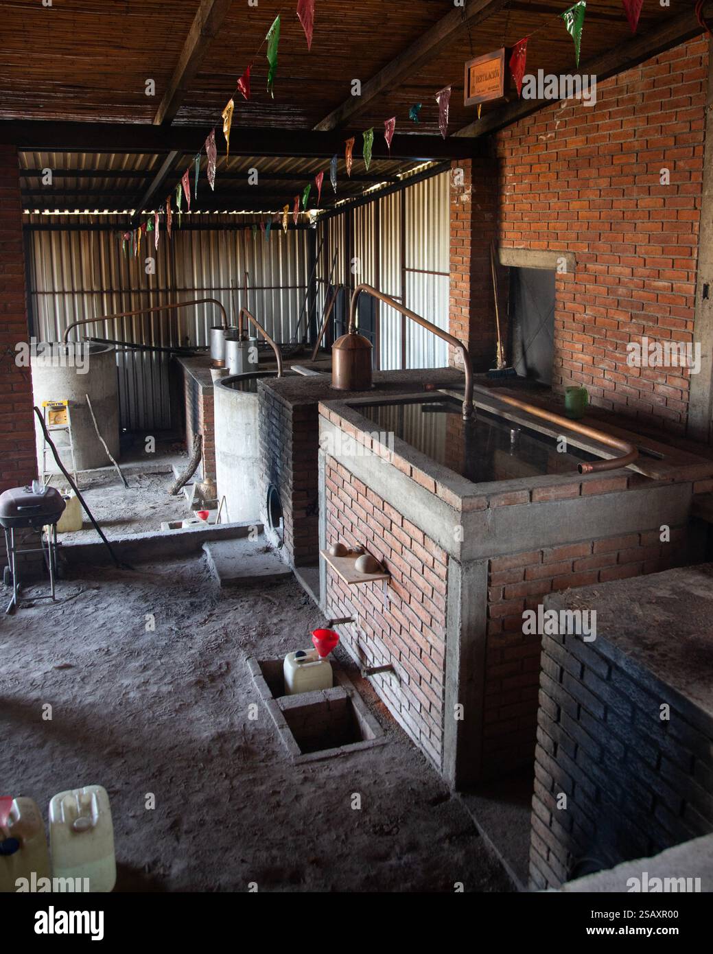 Mezcal is fermented and distilled in copper still tanks in artisanal ...