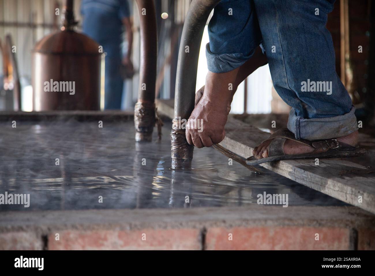 Mezcal is fermented and distilled in copper still tanks in artisanal ...
