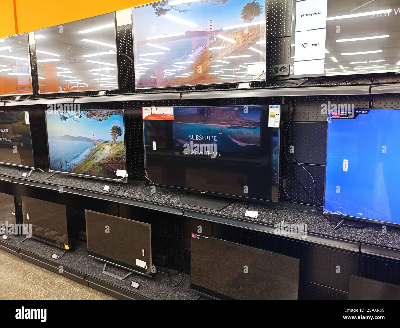 Modern flat-screen tvs on display shelf in electronics store Stock ...