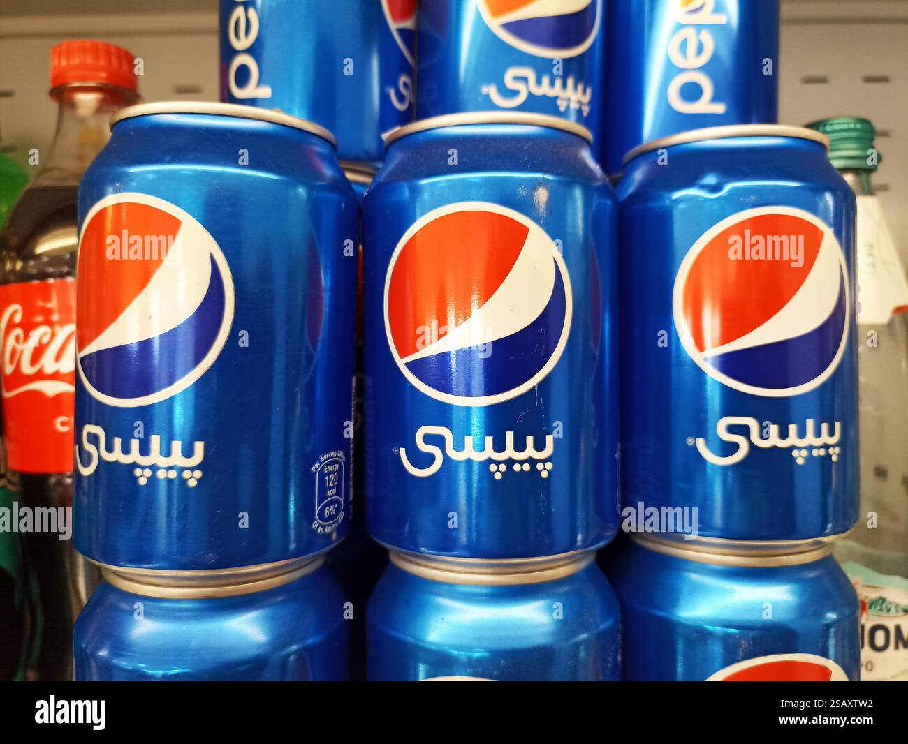 Pepsi logo on blue soda cans in retail display with arabic text Stock ...