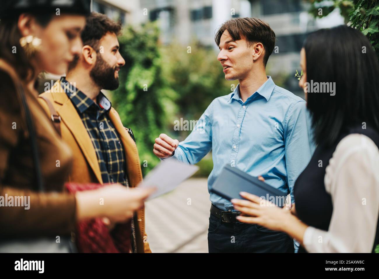 Business people having a discussion in an urban setting outdoors Stock ...