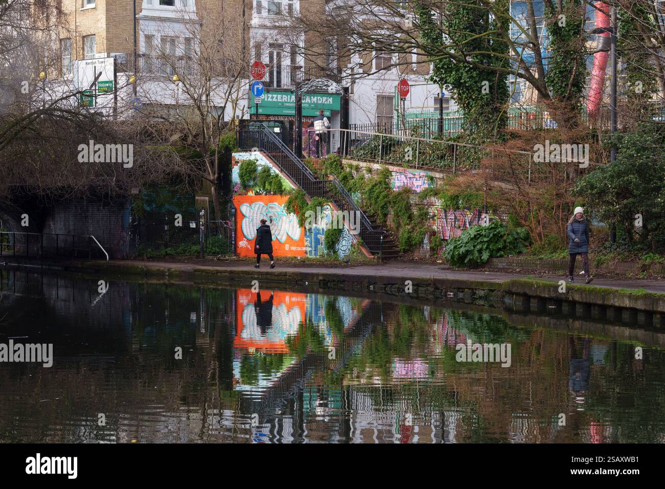 Members of the public walk the towpath at Somers Town on Regent's Canal ...