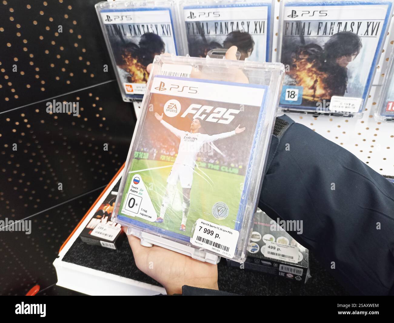 Person holding ps5 game pes 2021 at store display Stock Photo - Alamy