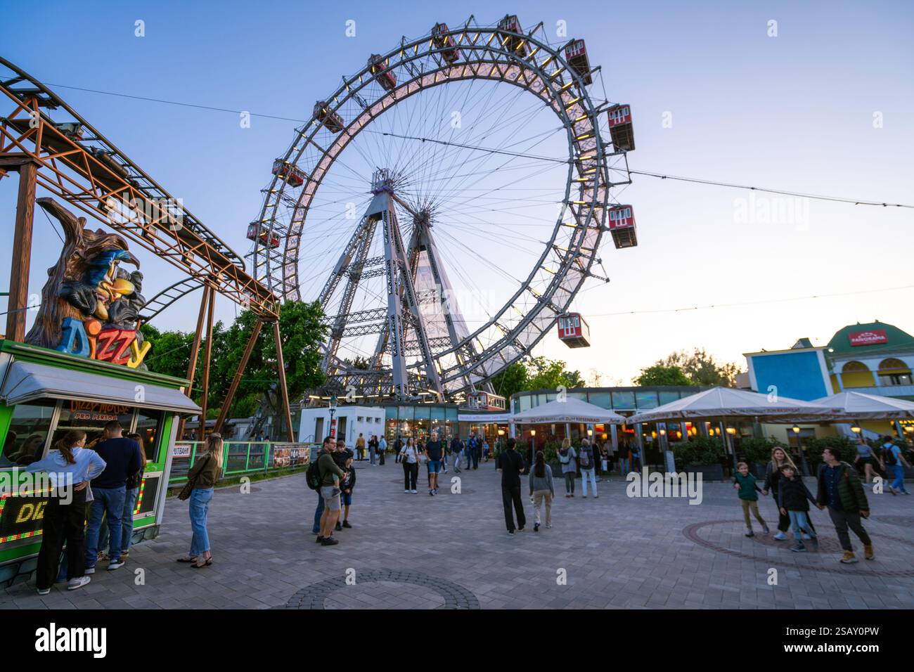 View of the ferris Wheel and rides at Prater Park, a famous urban park ...