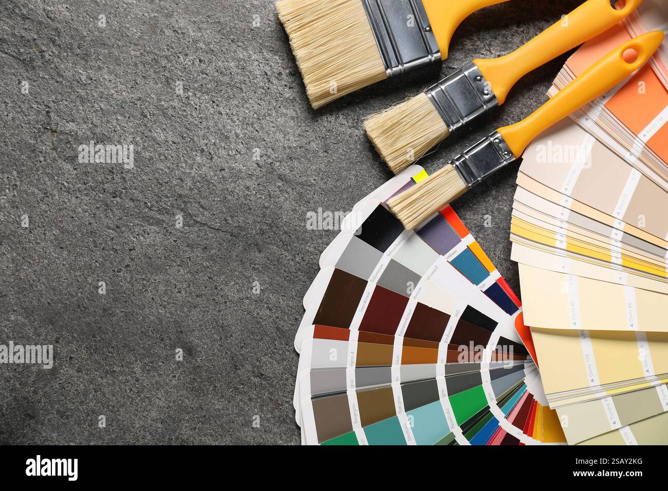 Color selection chart and paint brushes on grey table, flat lay with ...