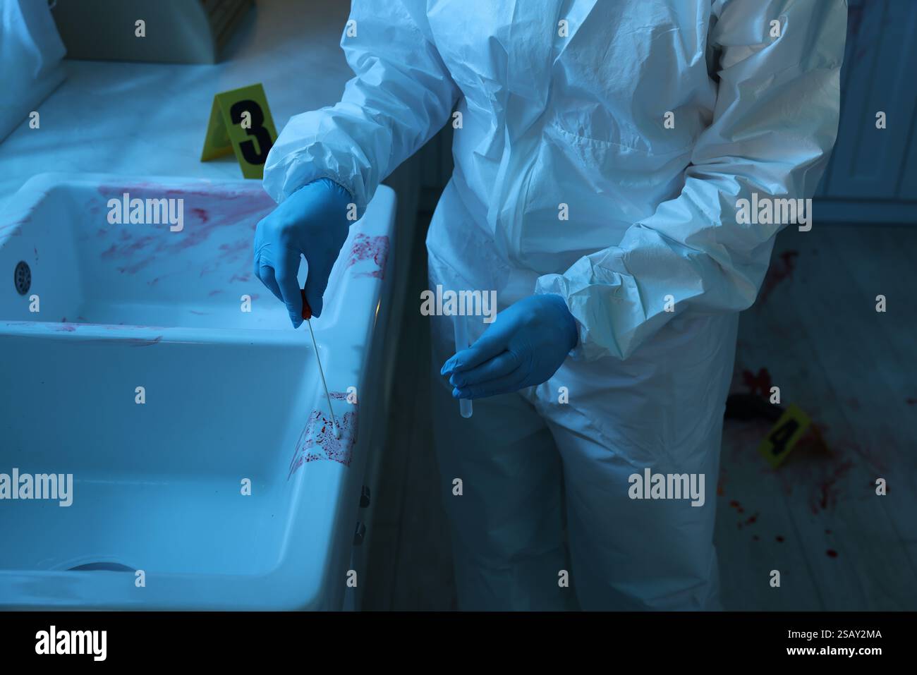 Forensic expert taking blood sample at crime scene indoors, closeup ...