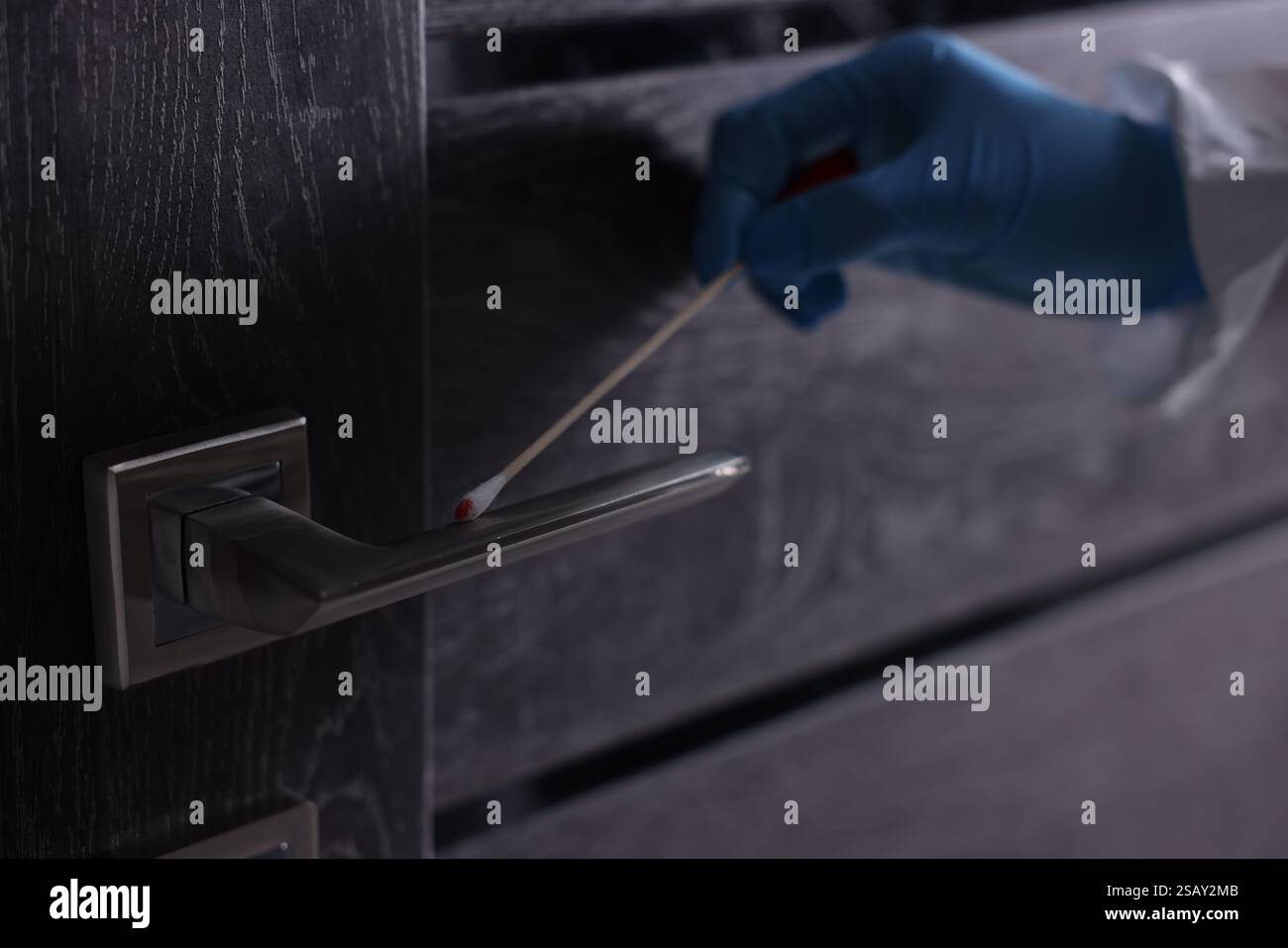 Forensic expert taking blood sample from handle of door, closeup Stock ...