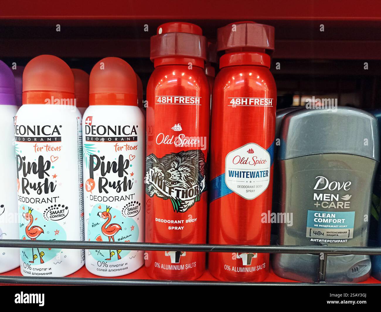 Variety of deodorant products on store shelf with bright packaging ...