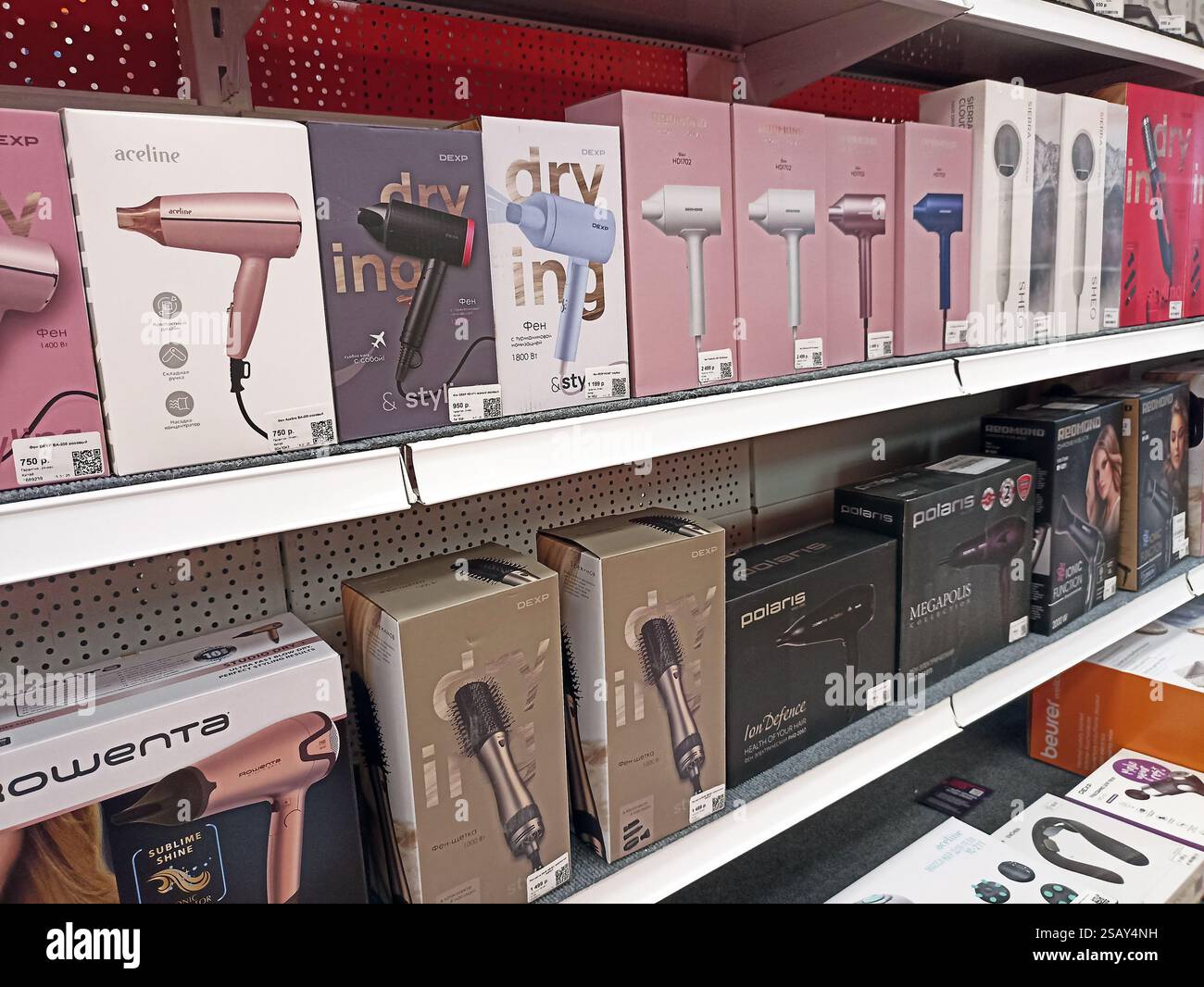 Variety of hair dryers and styling tools on store shelf Stock Photo - Alamy