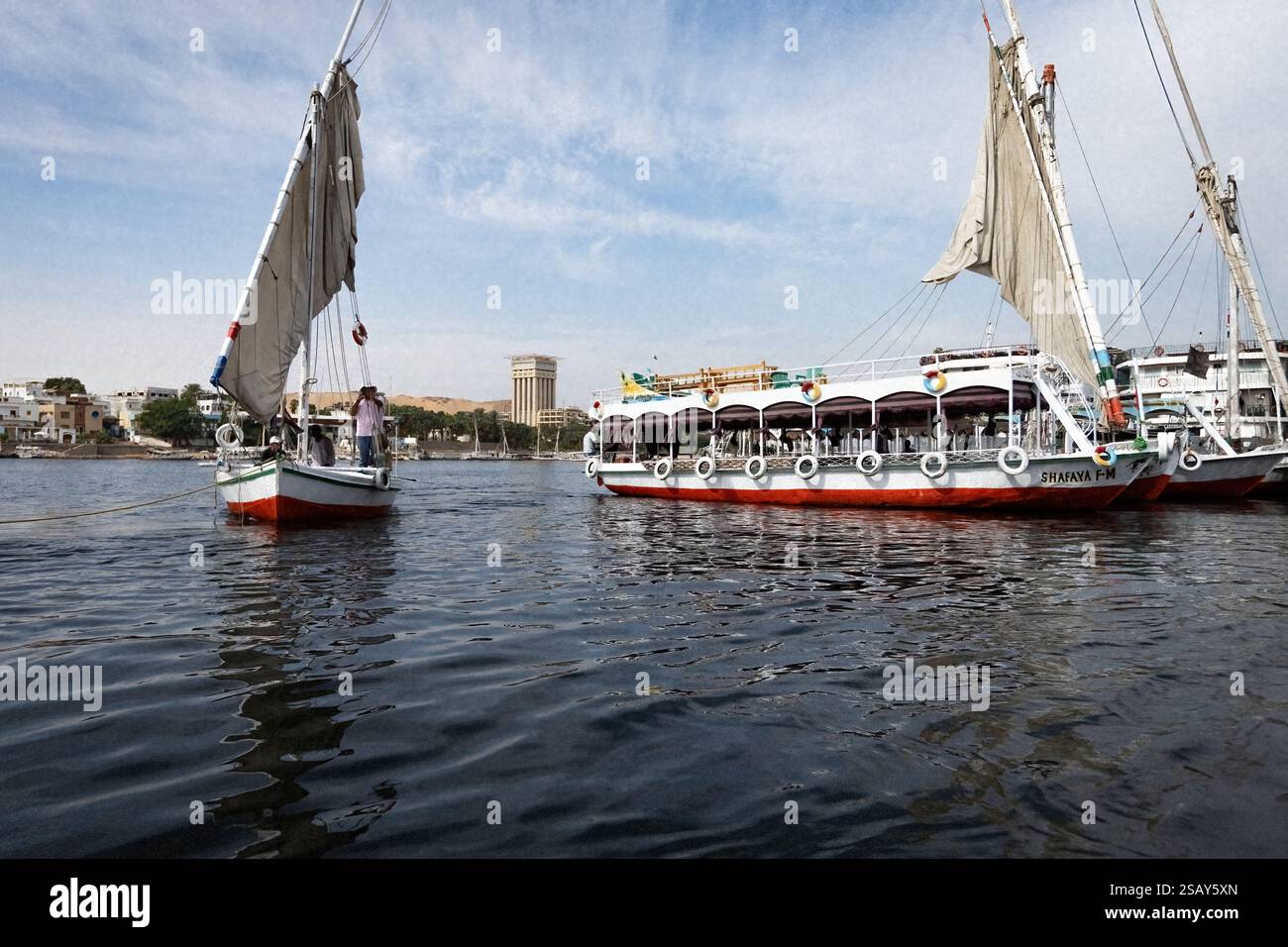 Traditional felucca sailboat on Nile at sunset, Aswan, Egypt Stock ...