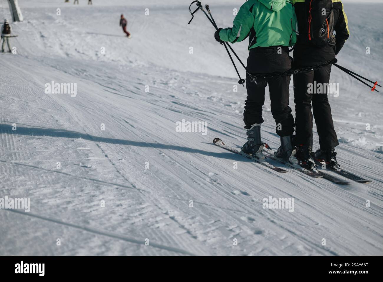 Two people skiing together on a snowy slope in a winter landscape Stock ...