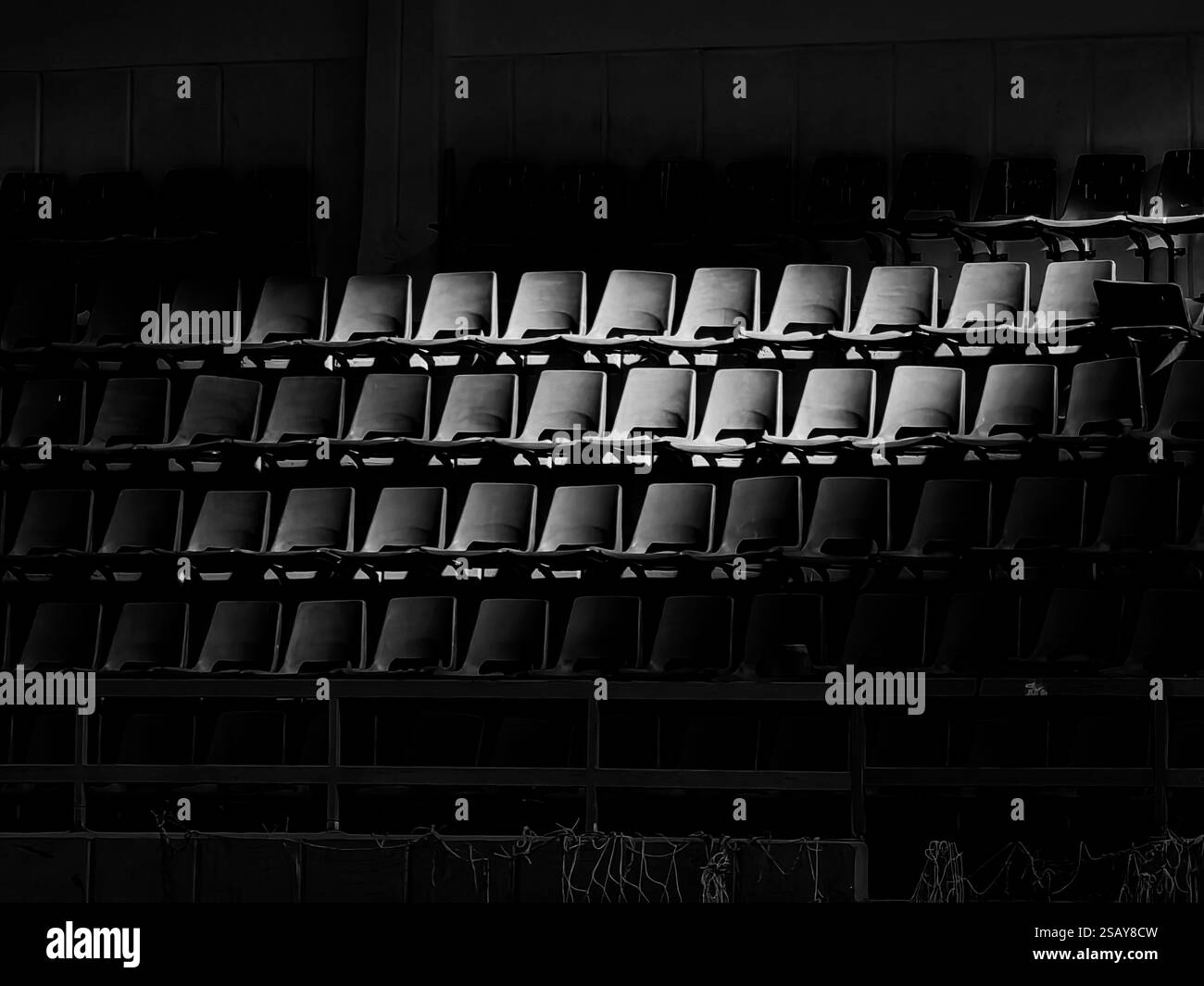Sunlit Contrast – Plastic Chairs in Light and Shadow Stock Photo - Alamy