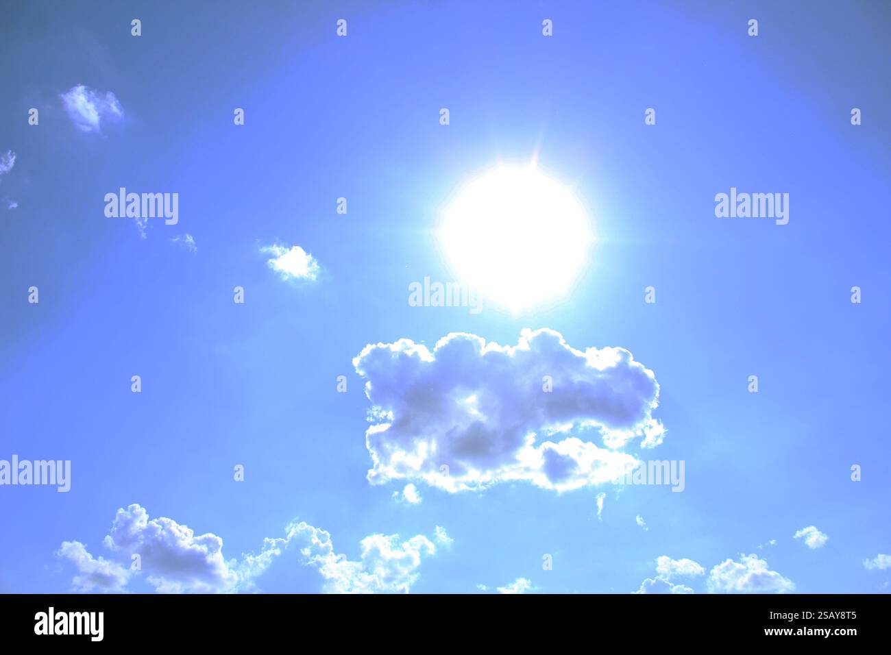 A blue sky with a white sun at its zenith. Noon Stock Photo - Alamy