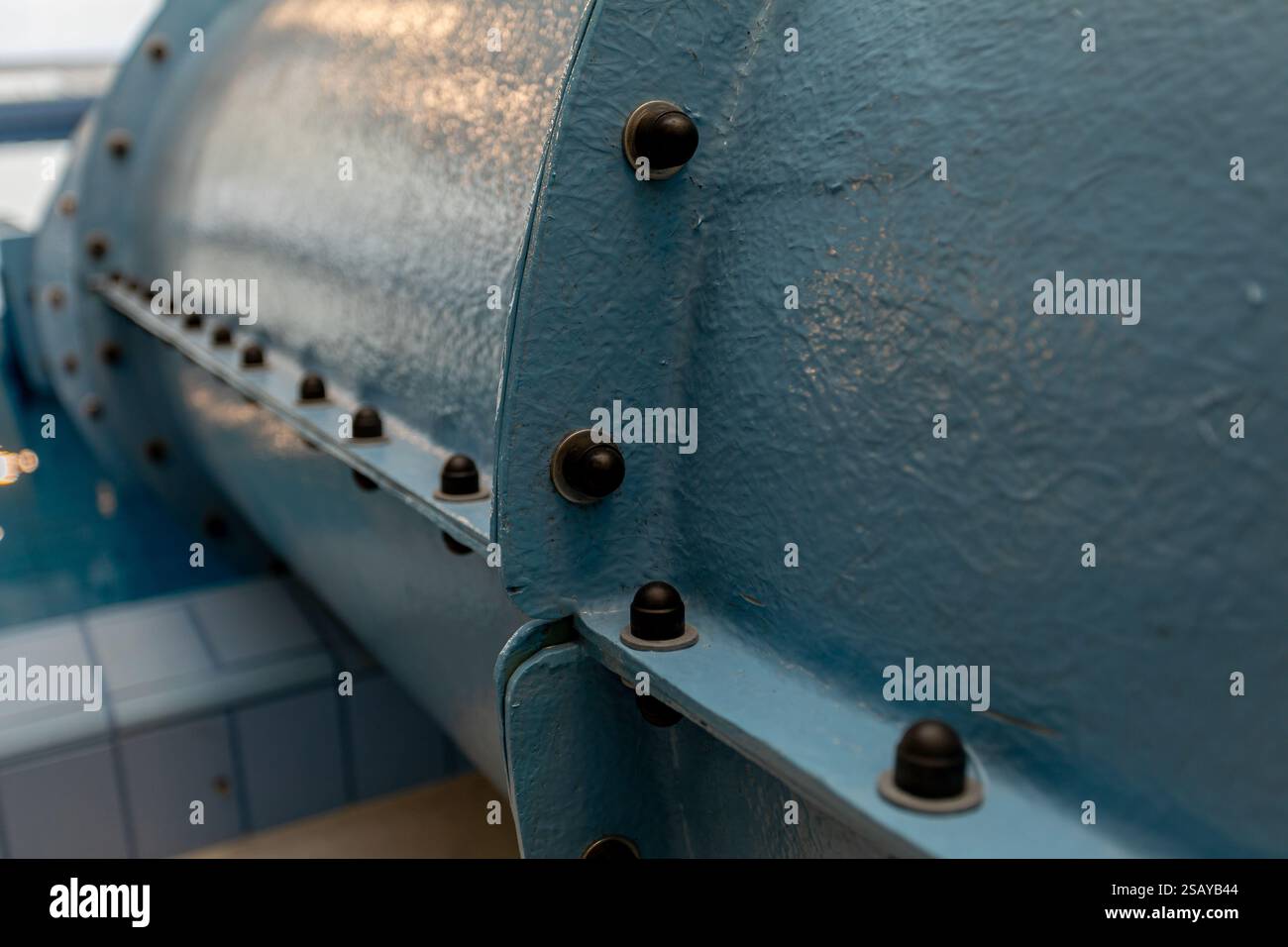 A CloseUp Image of an Industrial Blue Pipe Featuring Rivets and ...