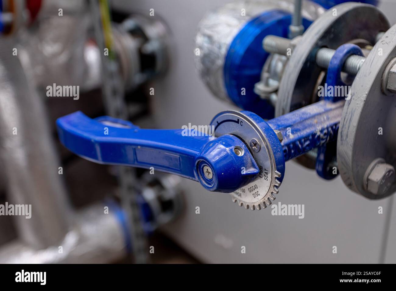 CloseUp of a Blue Valve Handle in Industrial Settings, highlighting its ...