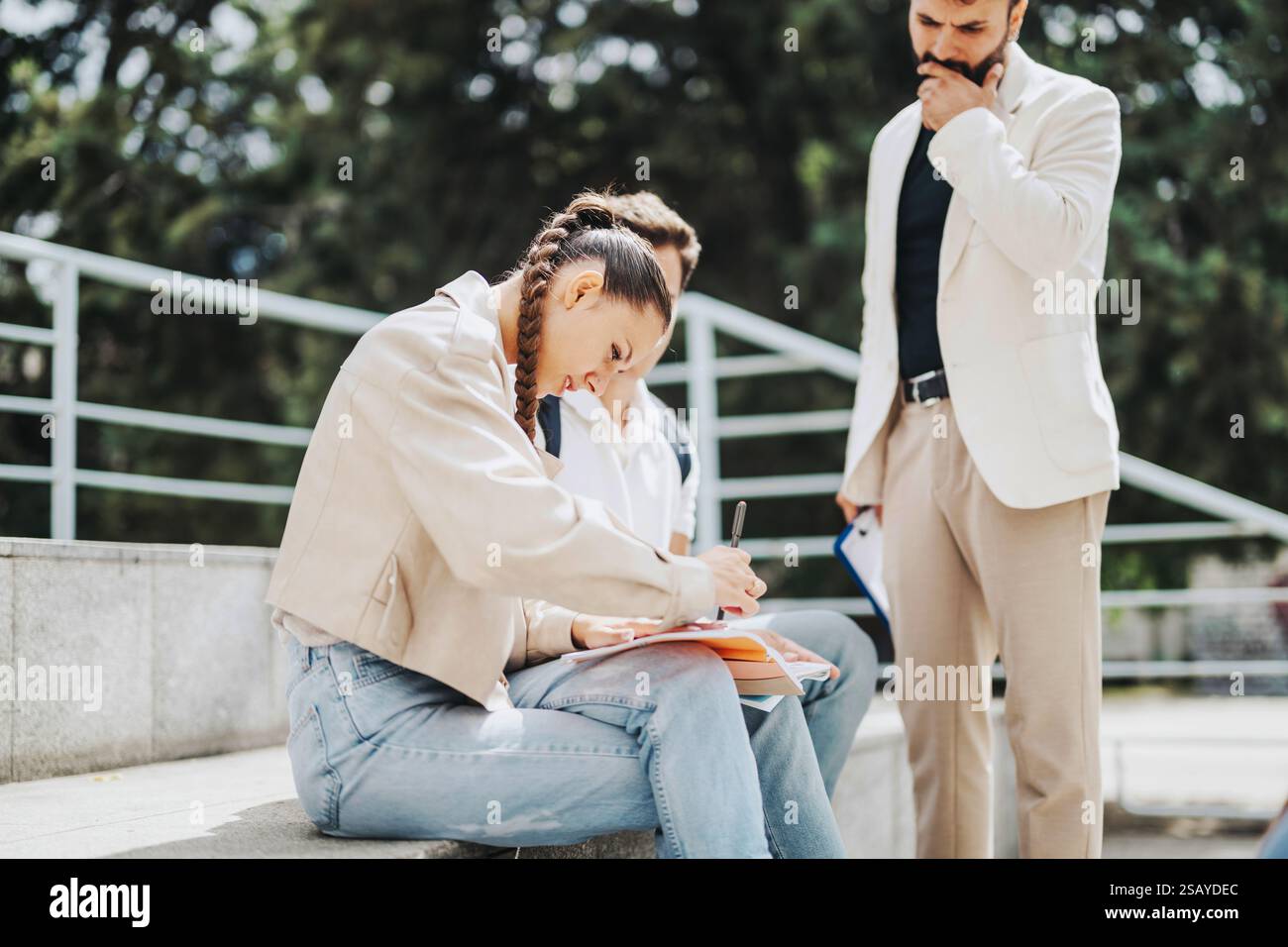 High school students learning outdoors with a thoughtful professor Stock Photo - Alamy