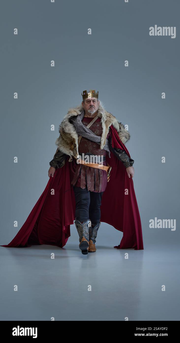 Man, medieval king walks forward with determination, cloak flowing ...