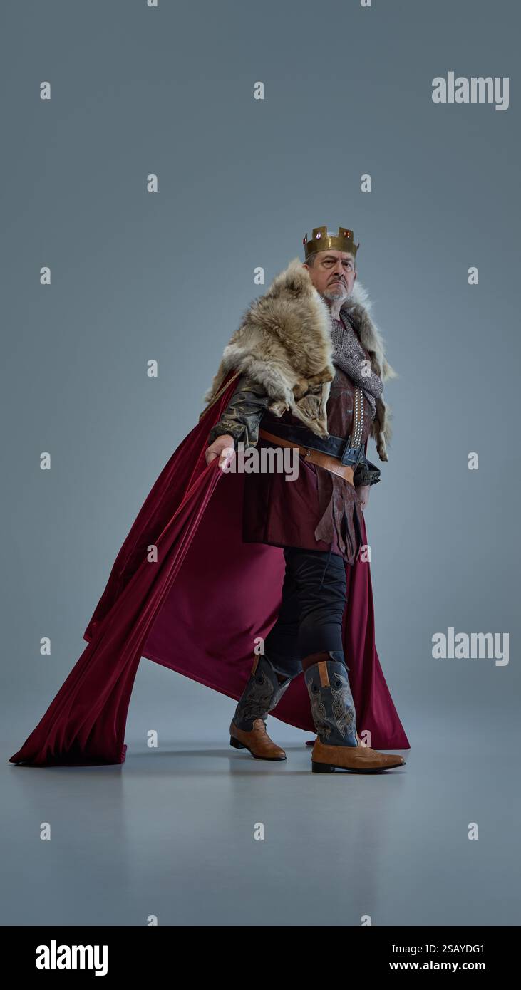 Elderly focused man, medieval king walks forward with determination ...