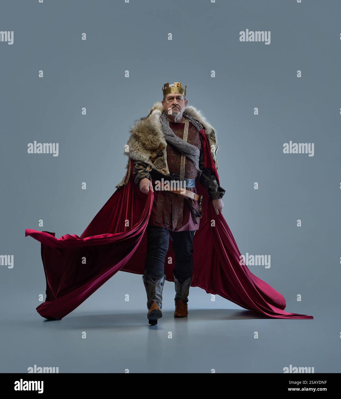 Elderly focused man, medieval king walks forward with determination ...