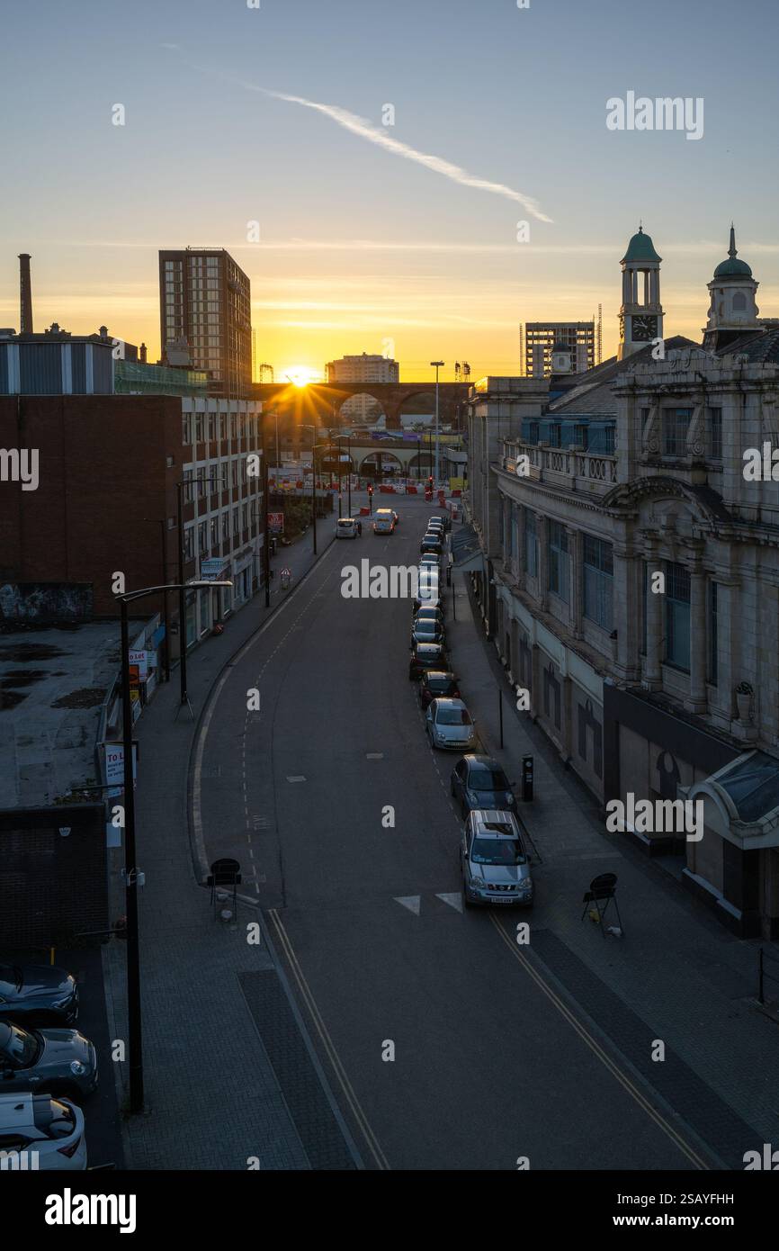 This is a view of a street in Stockport City Centre during sunset on ...