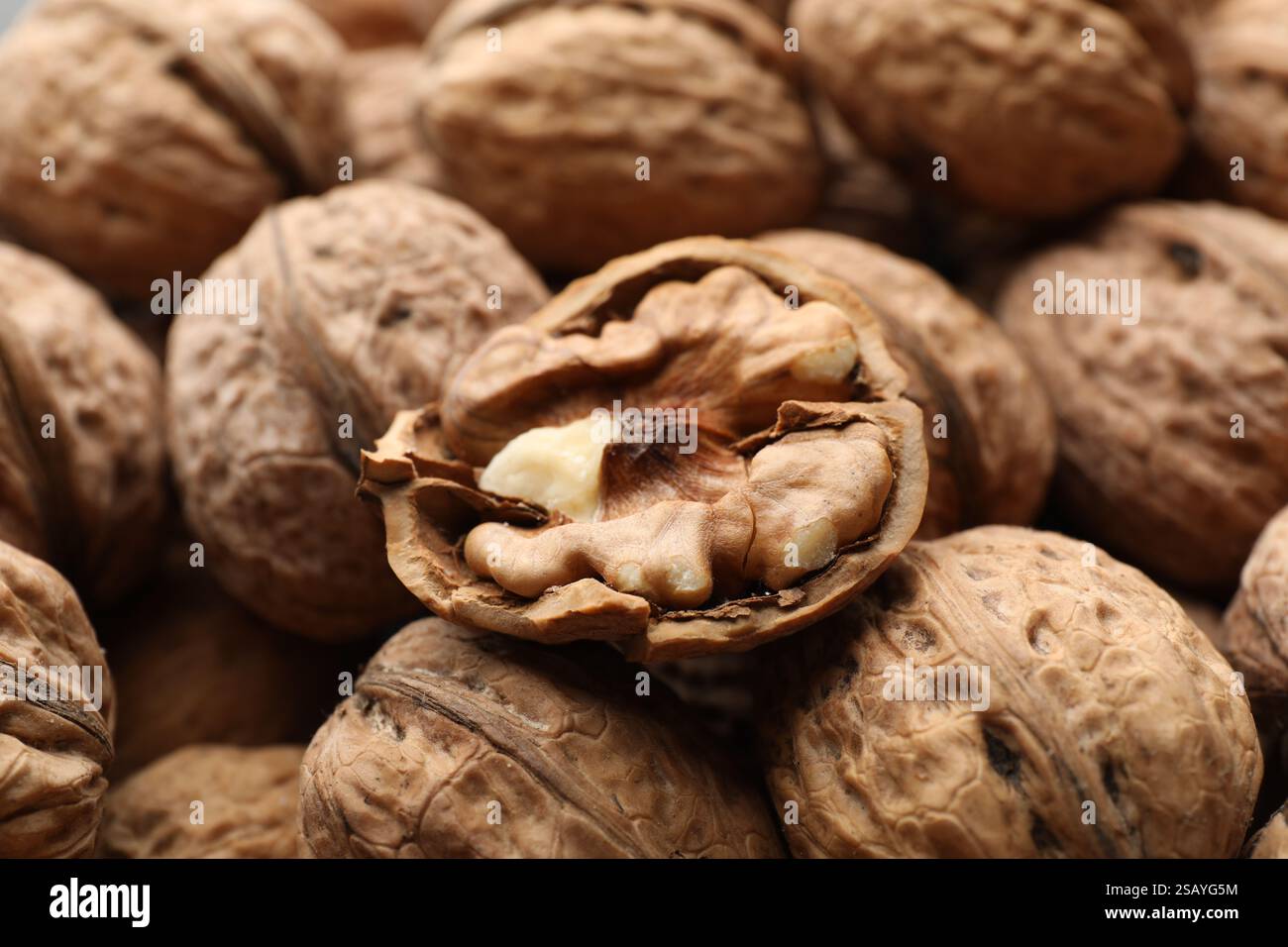Fresh walnuts in shells as background, closeup Stock Photo - Alamy