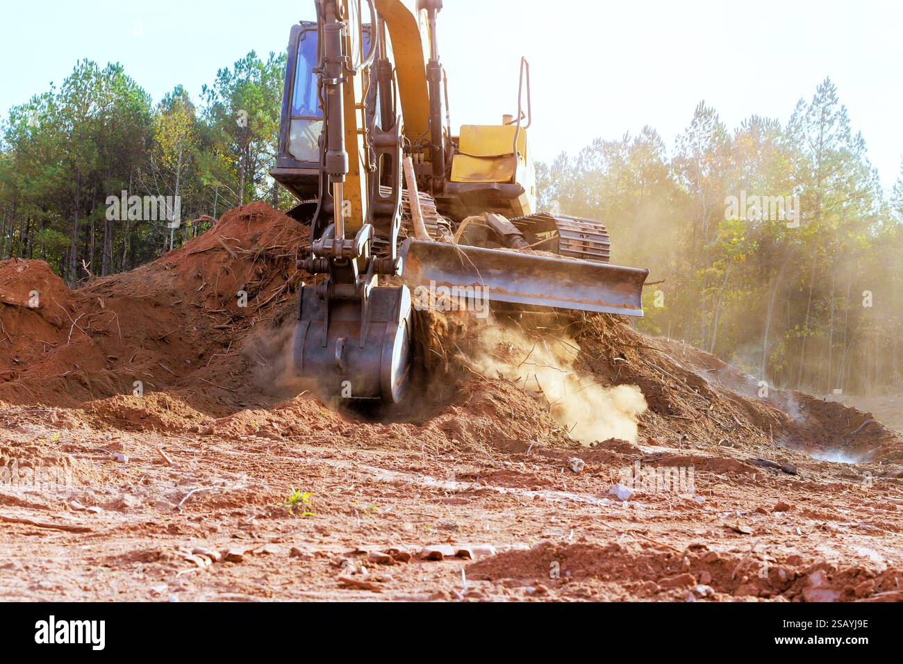 Heavy excavator is actively moving dirt, debris at construction site ...
