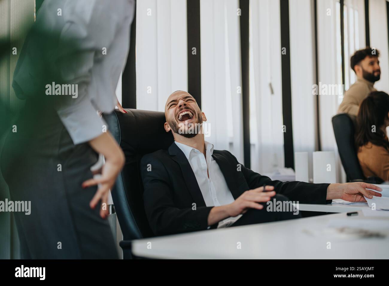 Colleagues Laughing Together in a Collaborative Business Office Setting ...