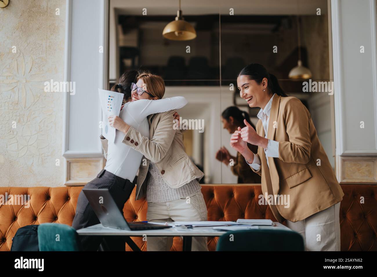Female coworkers celebrating success with joy and camaraderie in the ...