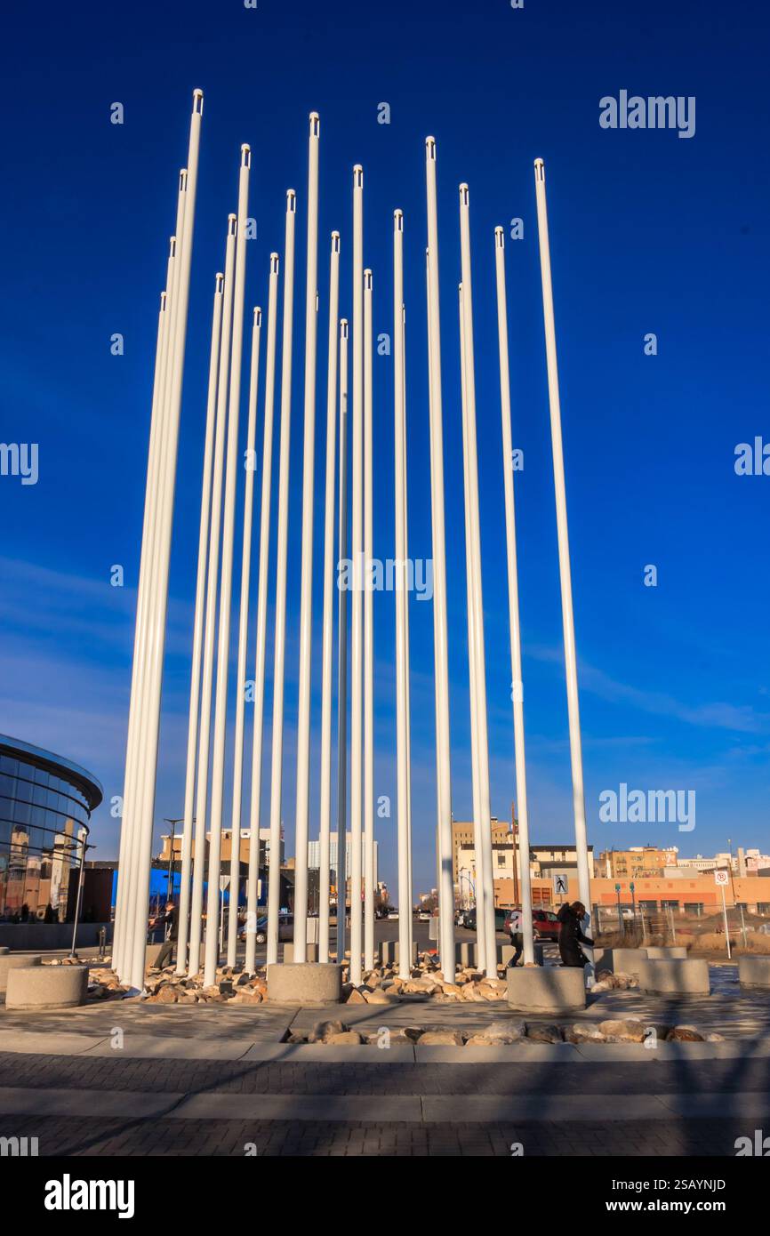 A tall white pole with many poles attached to it. The pole is in front ...